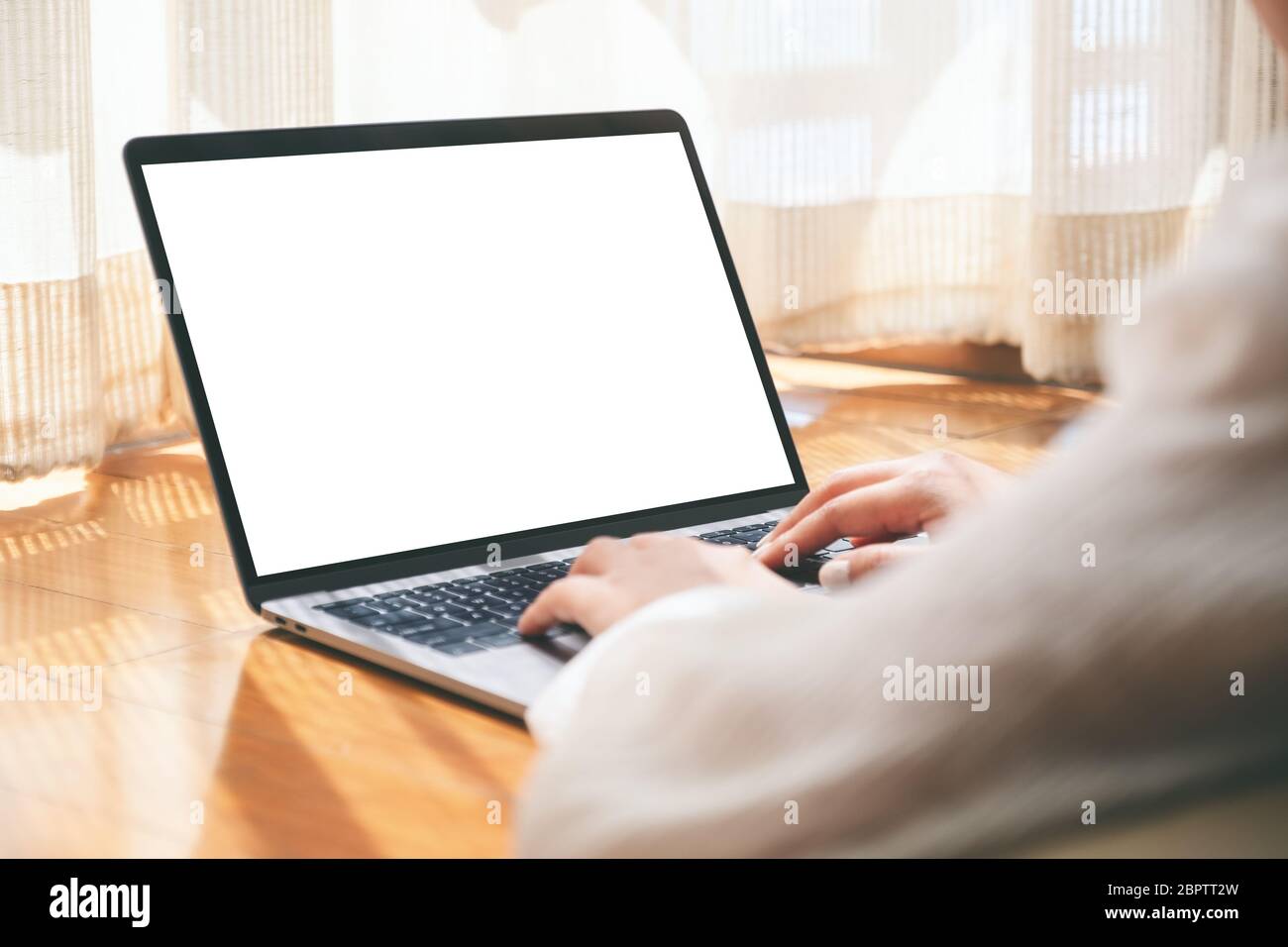 Mockup image of a woman using laptop computer with blank white desktop ...