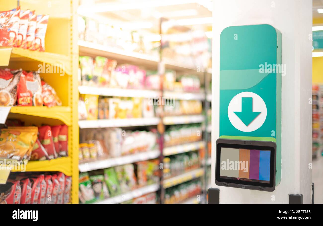 The barcode price scanner on the wall in a supermarket for self service ...