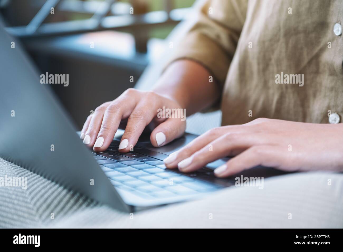 Closeup image of woman's hands using and typing on laptop keyboard ...