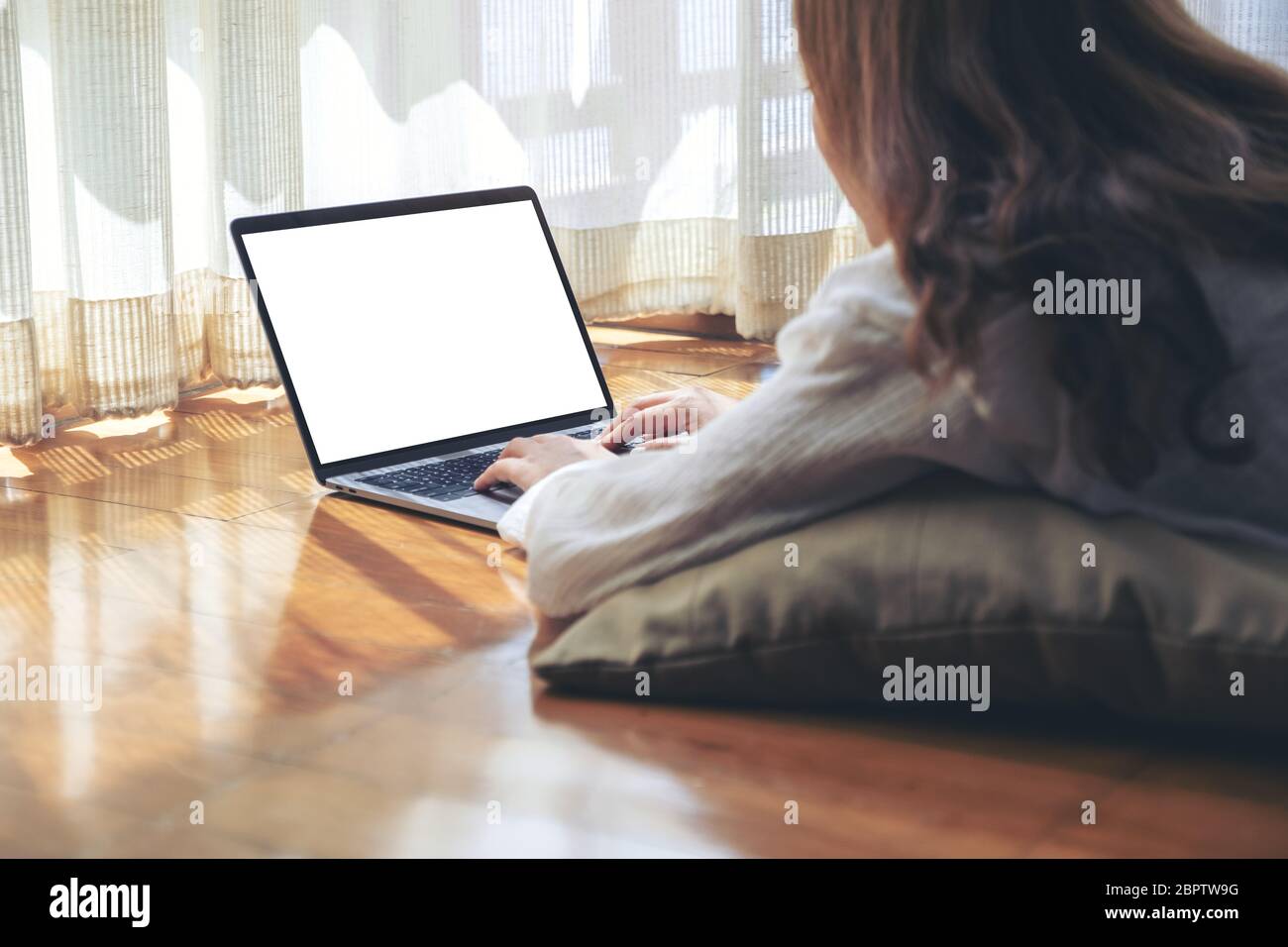 Mockup image of a woman typing on laptop computer with blank white ...