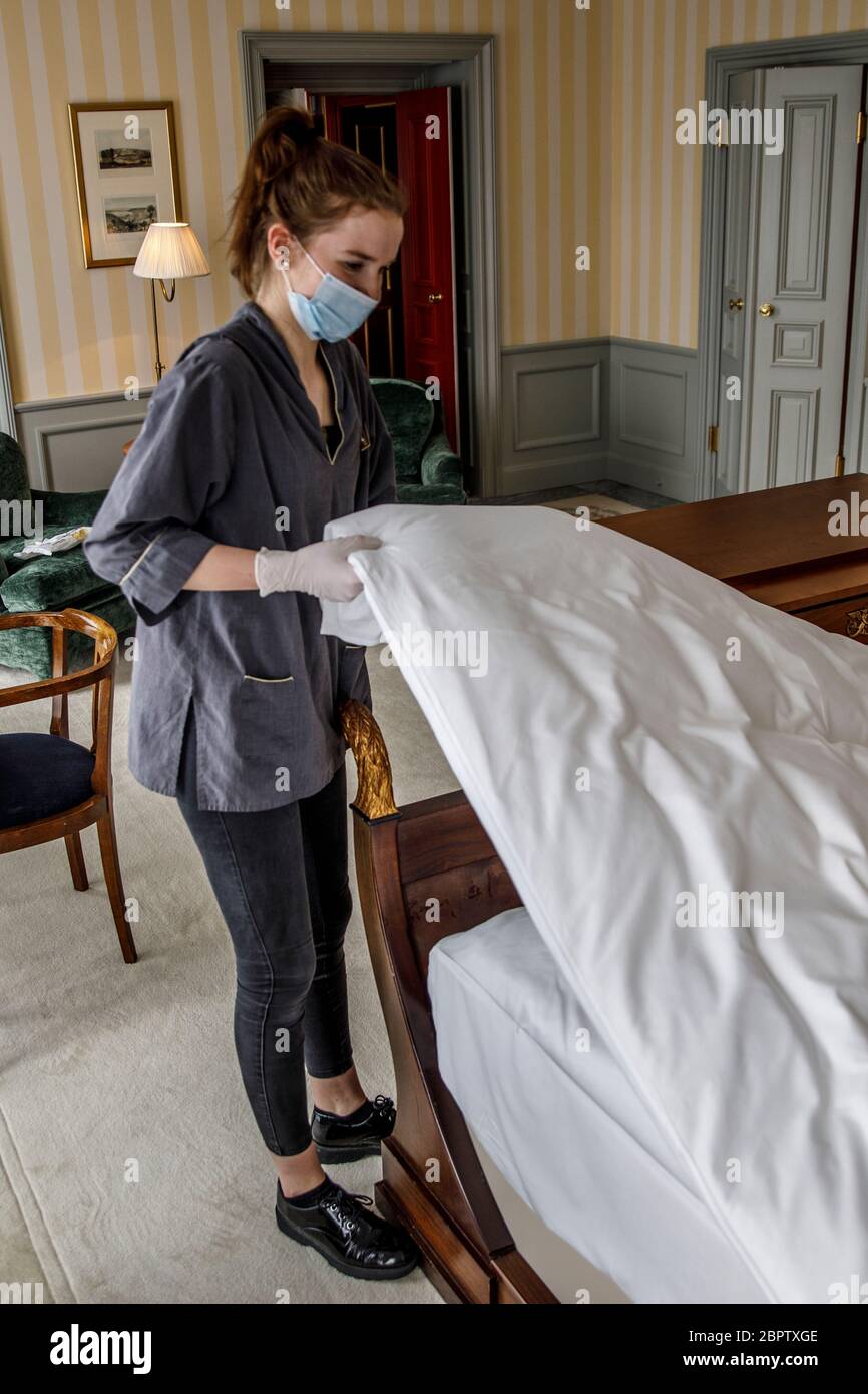Berlin, Germany. 19th May, 2020. A housekeeper with a mouth-and-nose ...