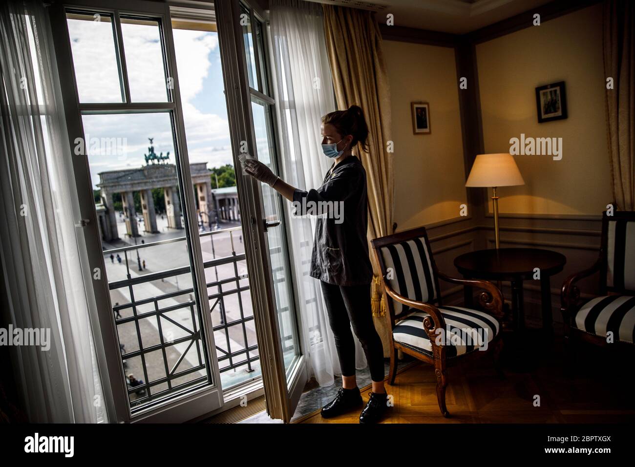 Berlin, Germany. 19th May, 2020. A housekeeper with a mouth and nose ...