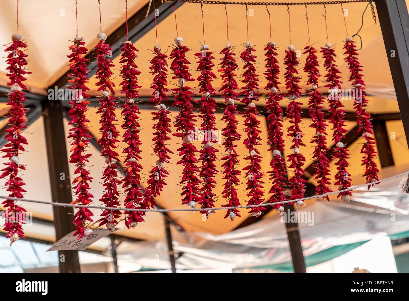 Red chili pepper hanging from a little chain in the market Stock Photo ...