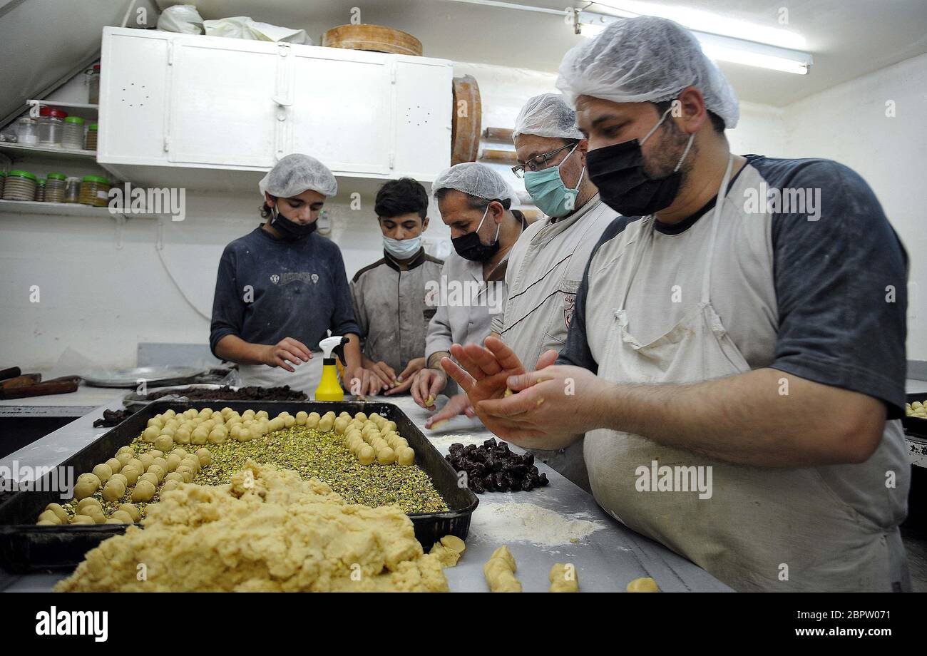 Damascus, Syria. 19th May, 2020. Patissiers make Ma'amoul, a kind of ...