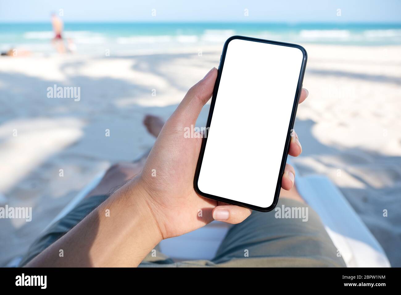 Mockup image of a man's hand holding white mobile phone with blank ...