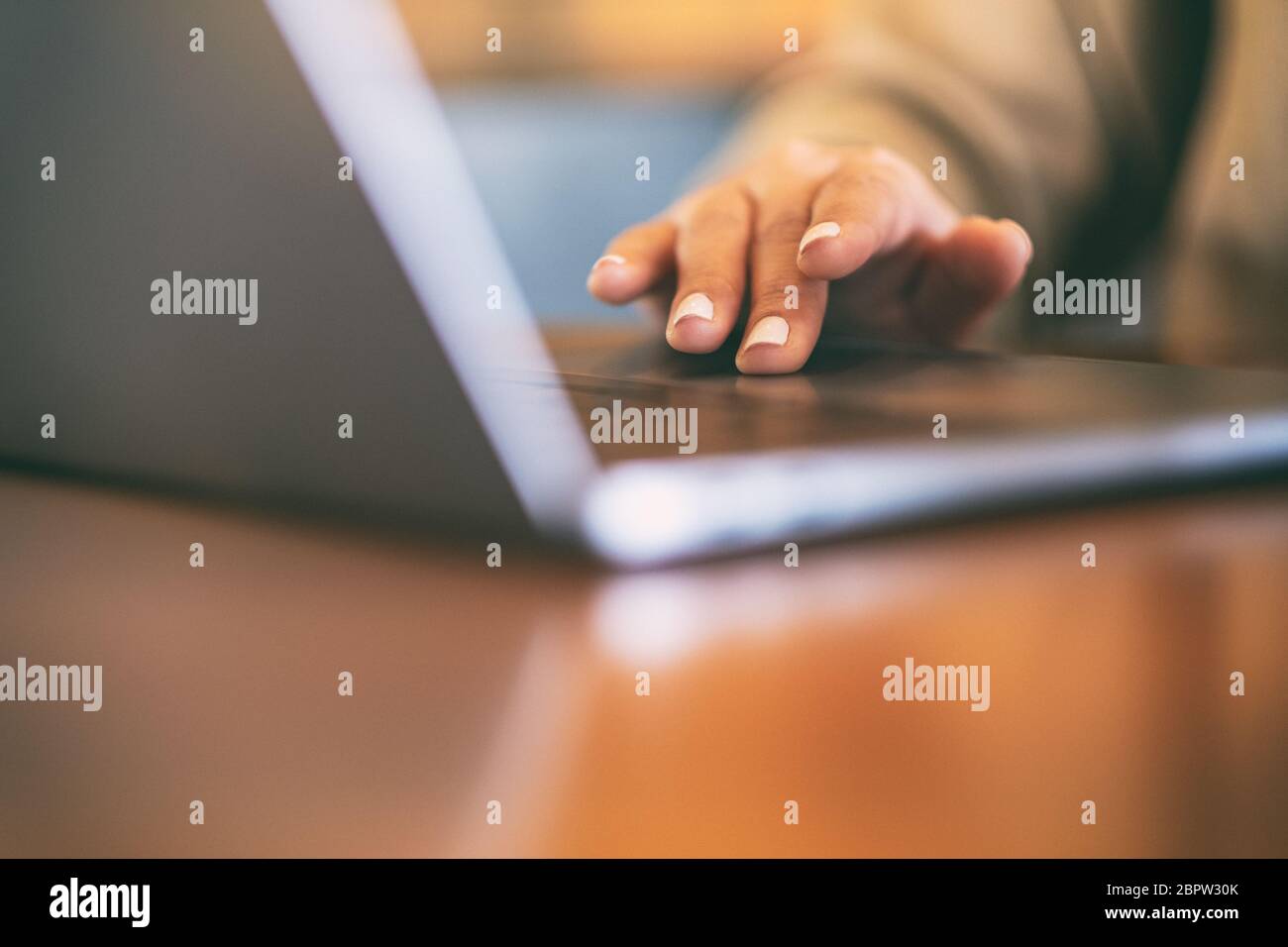Closeup image of a woman using and touching on laptop computer touchpad ...