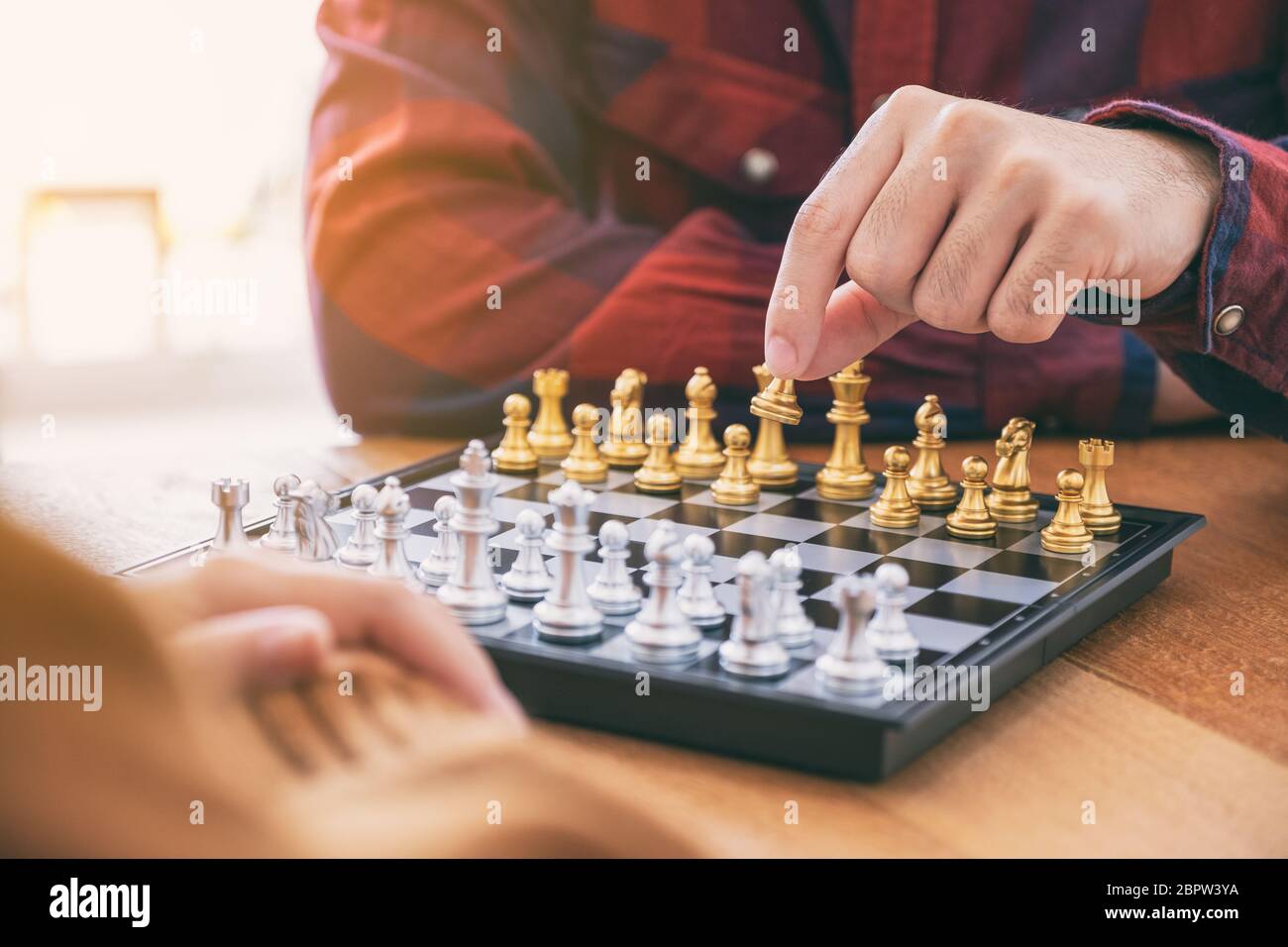 Closeup image of a man moving and playing chessboard game together ...
