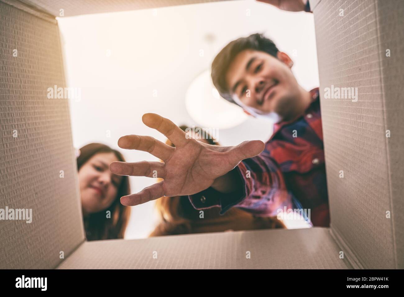 Group of young people opening and grabbing a gift in the box Stock ...