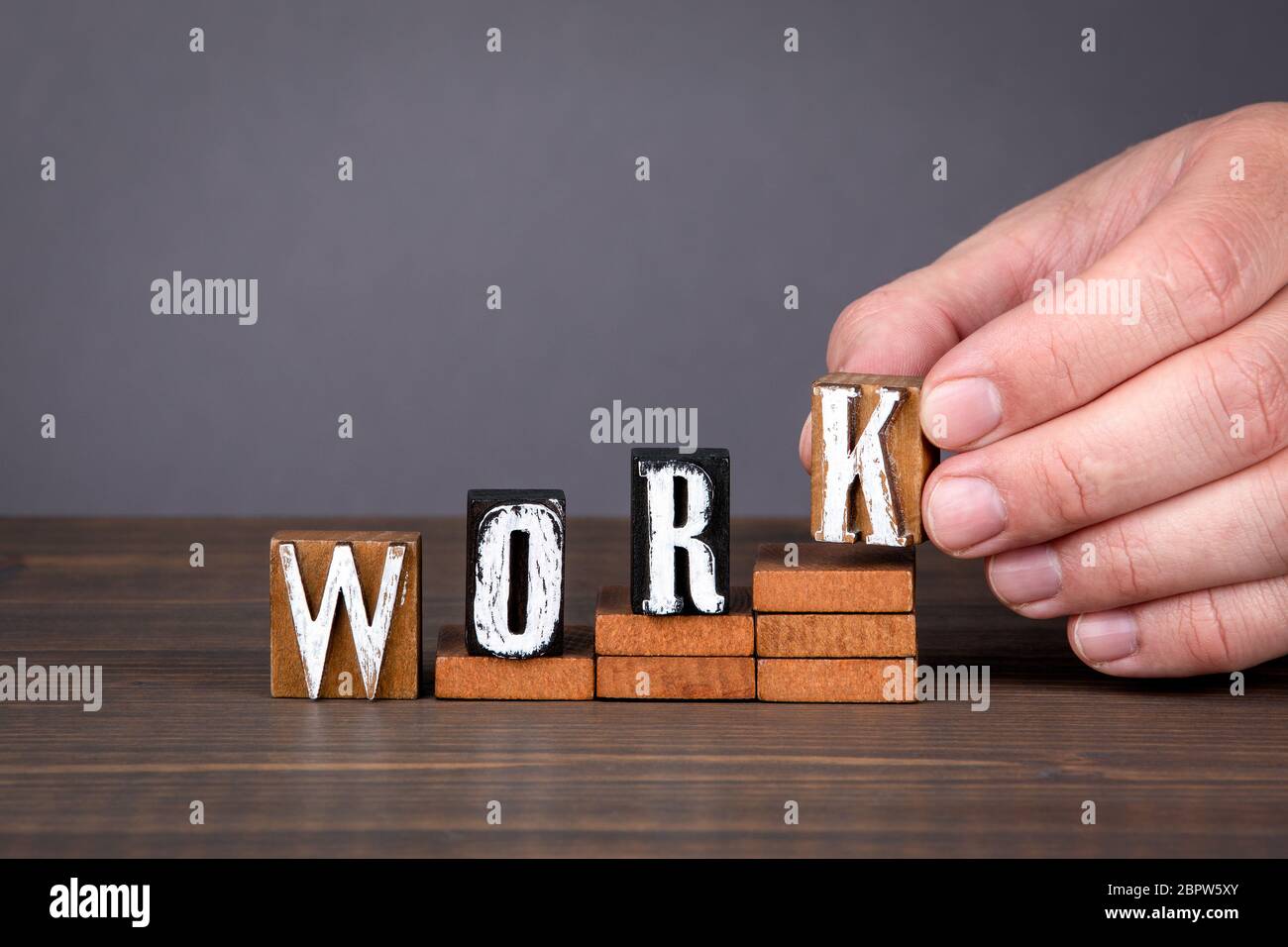 WORK concept. Wooden alphabet letters on steps. Gray background Stock ...