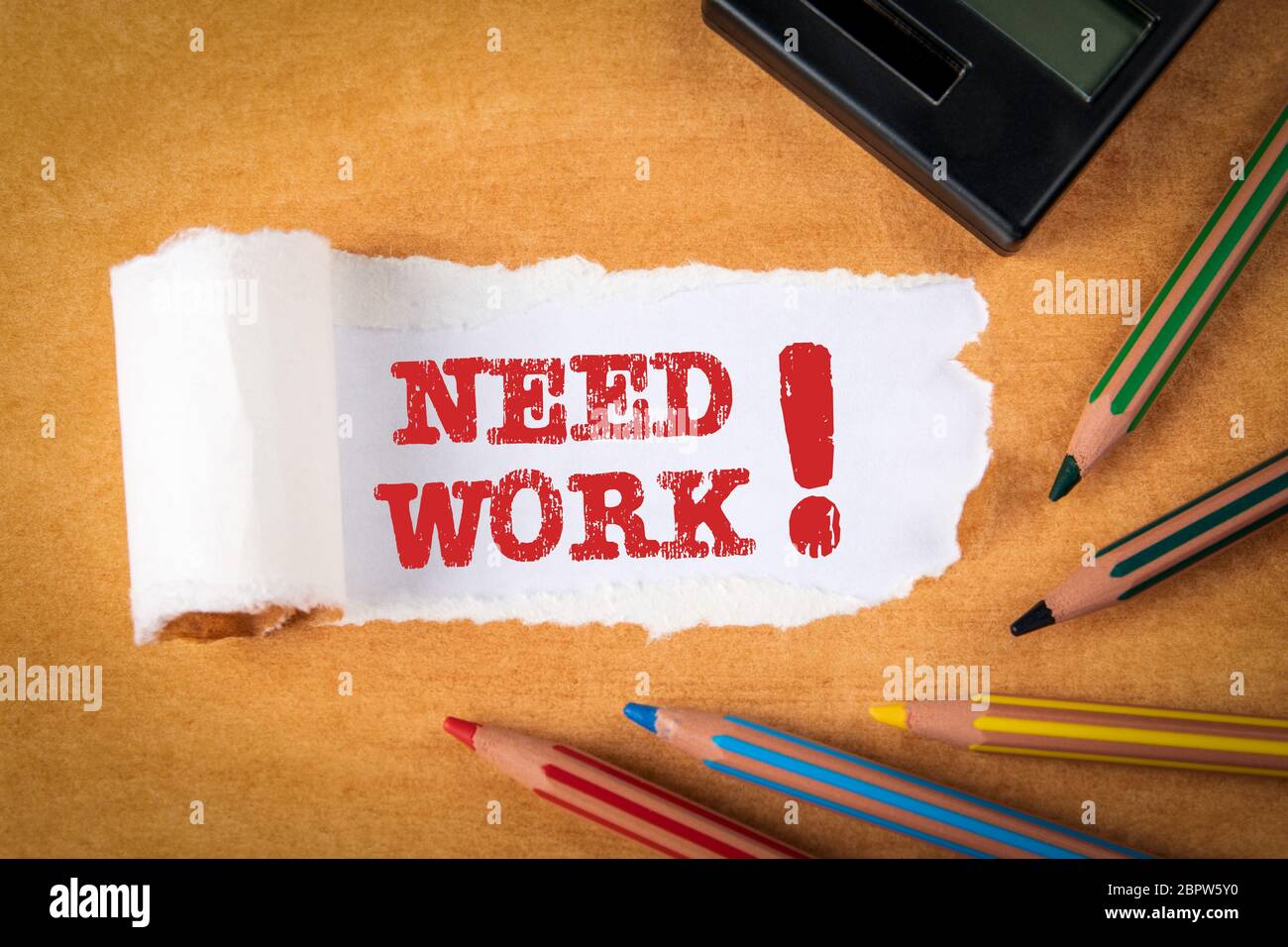 NEED WORK concept. Text under torn paper. Pencils and office supplies ...