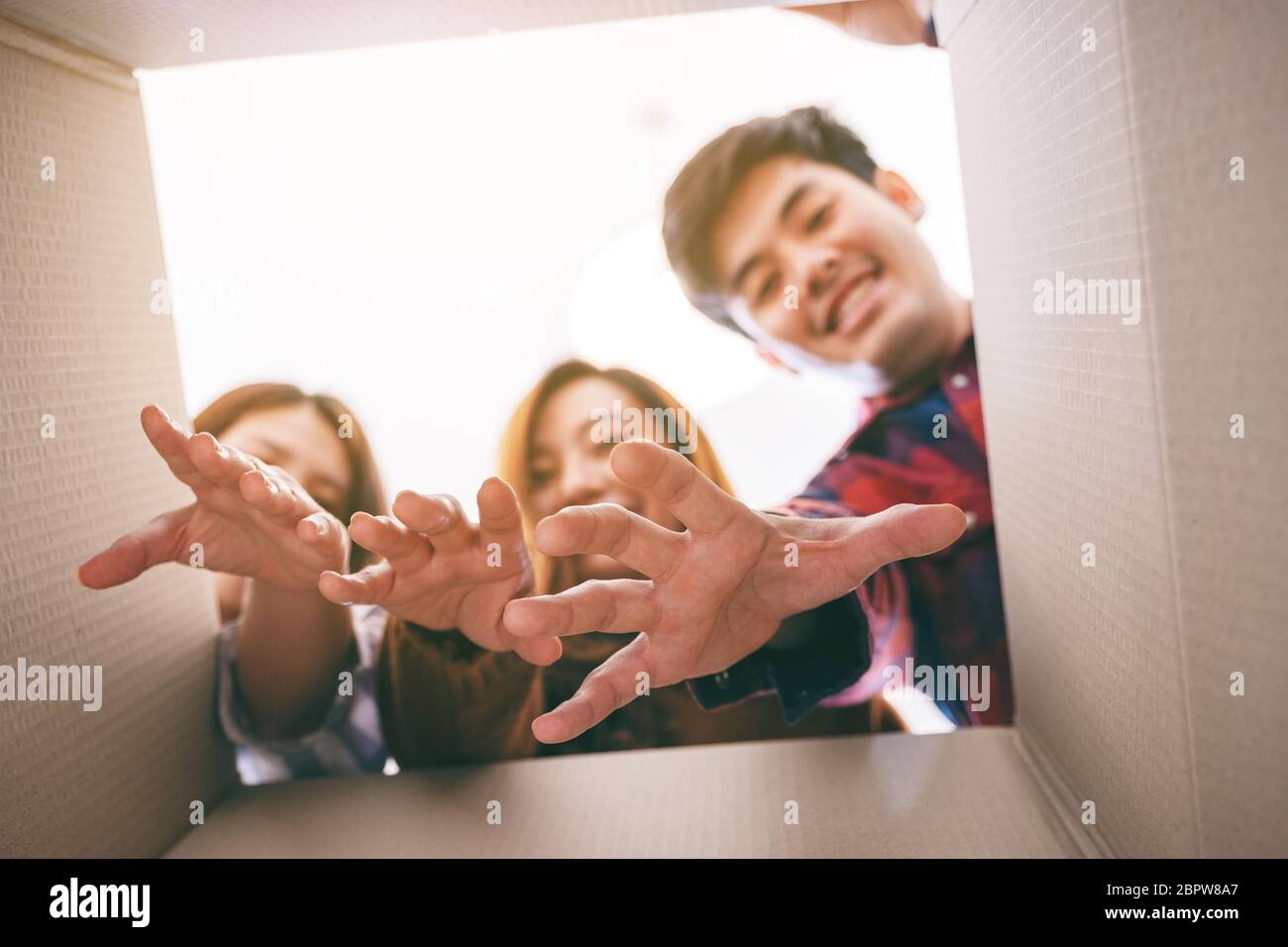 Group of young people opening and grabbing a gift in the box Stock ...