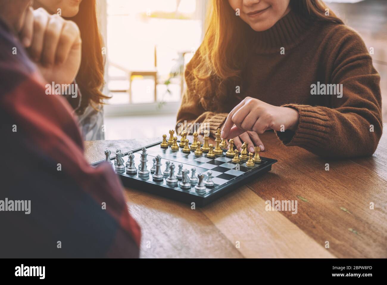 Closeup image of people moving and playing chessboard game together ...