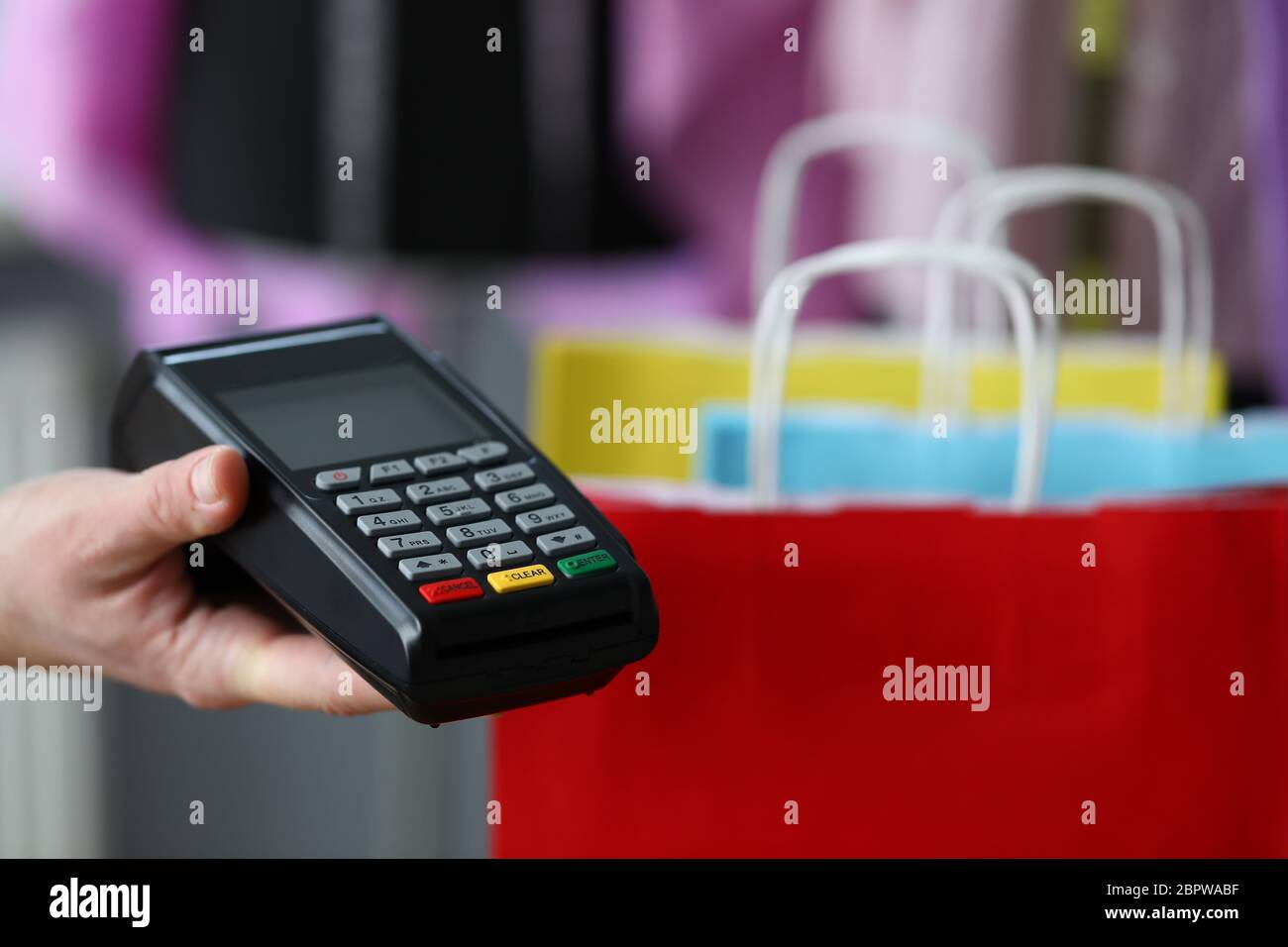 Store worker giving device Stock Photo - Alamy