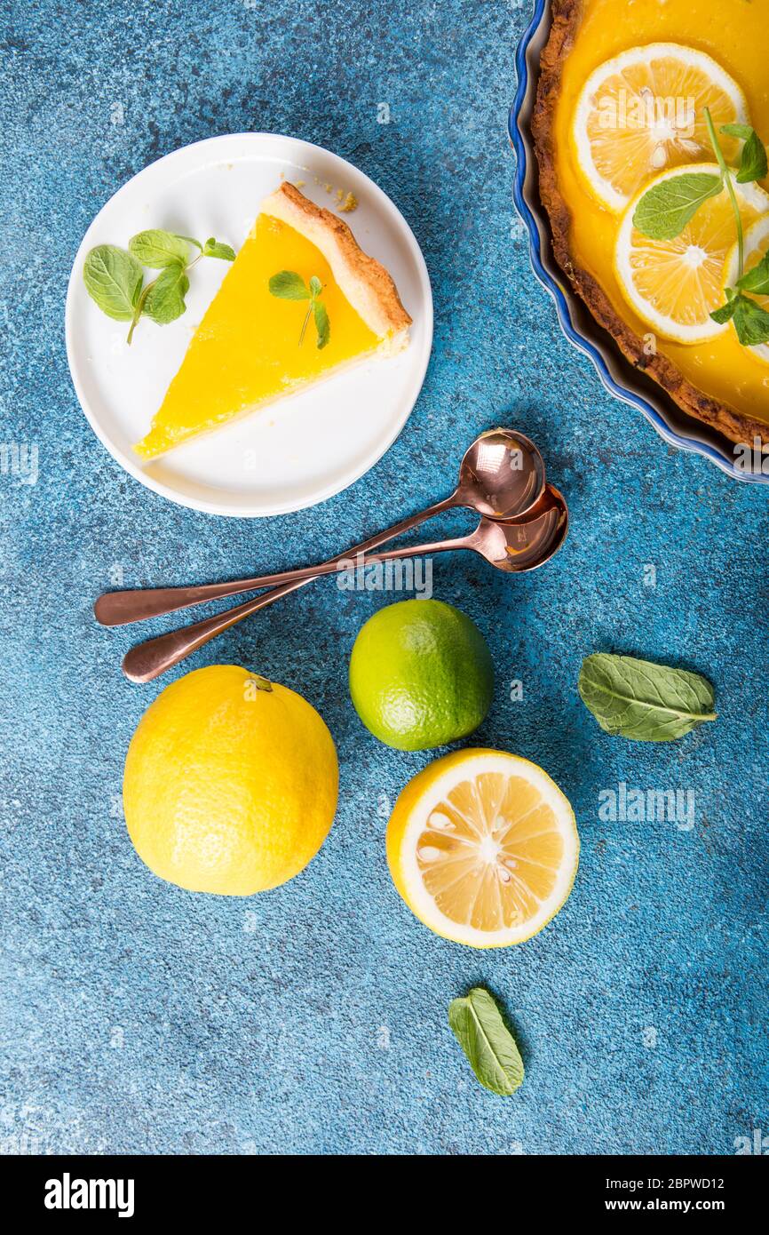 Food concept Homemade organic Lemon, lime tarts or cake pie on blue ...