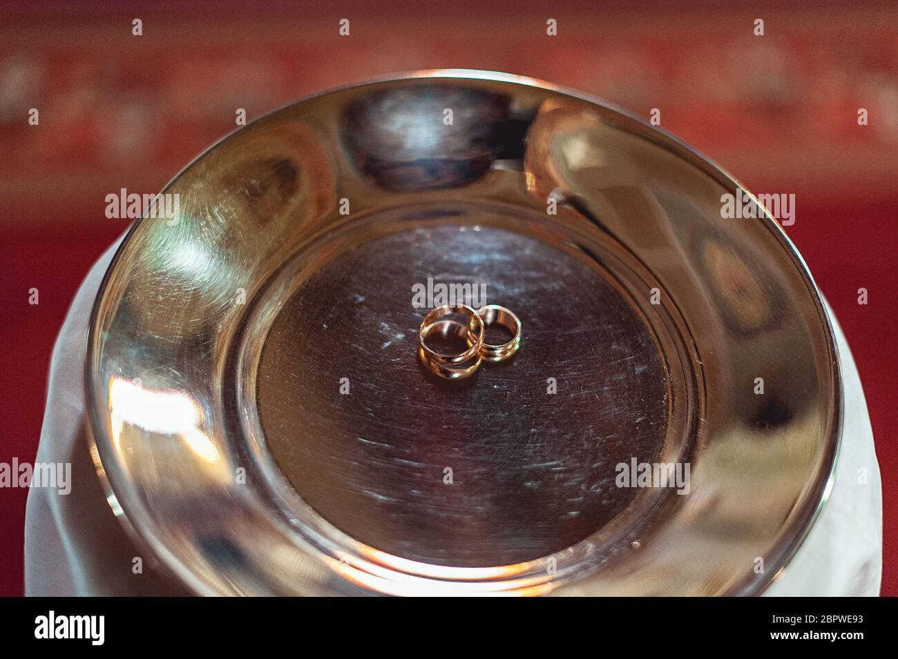 Classic gold wedding ring on a gold plate Stock Photo - Alamy