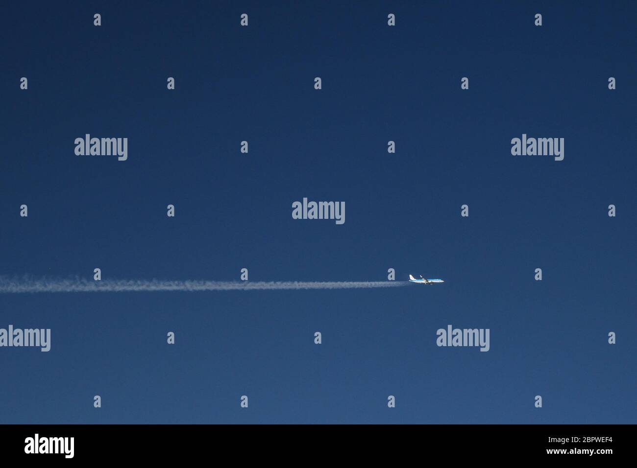 Airplane in the sky - KLM airline. Horizontal trajectory on blue sky ...