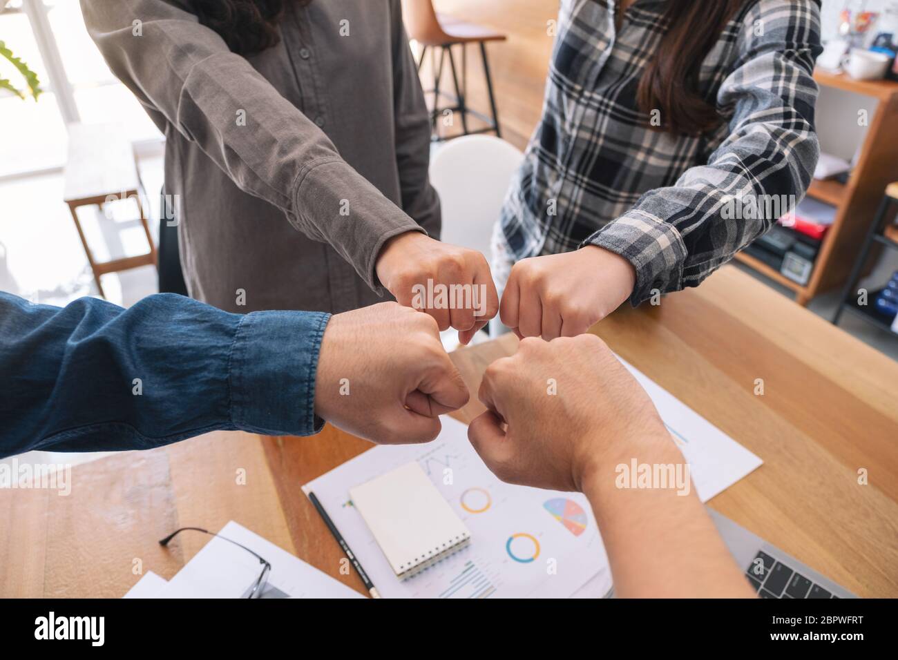 Group of business teamwork join their hands together with power and ...