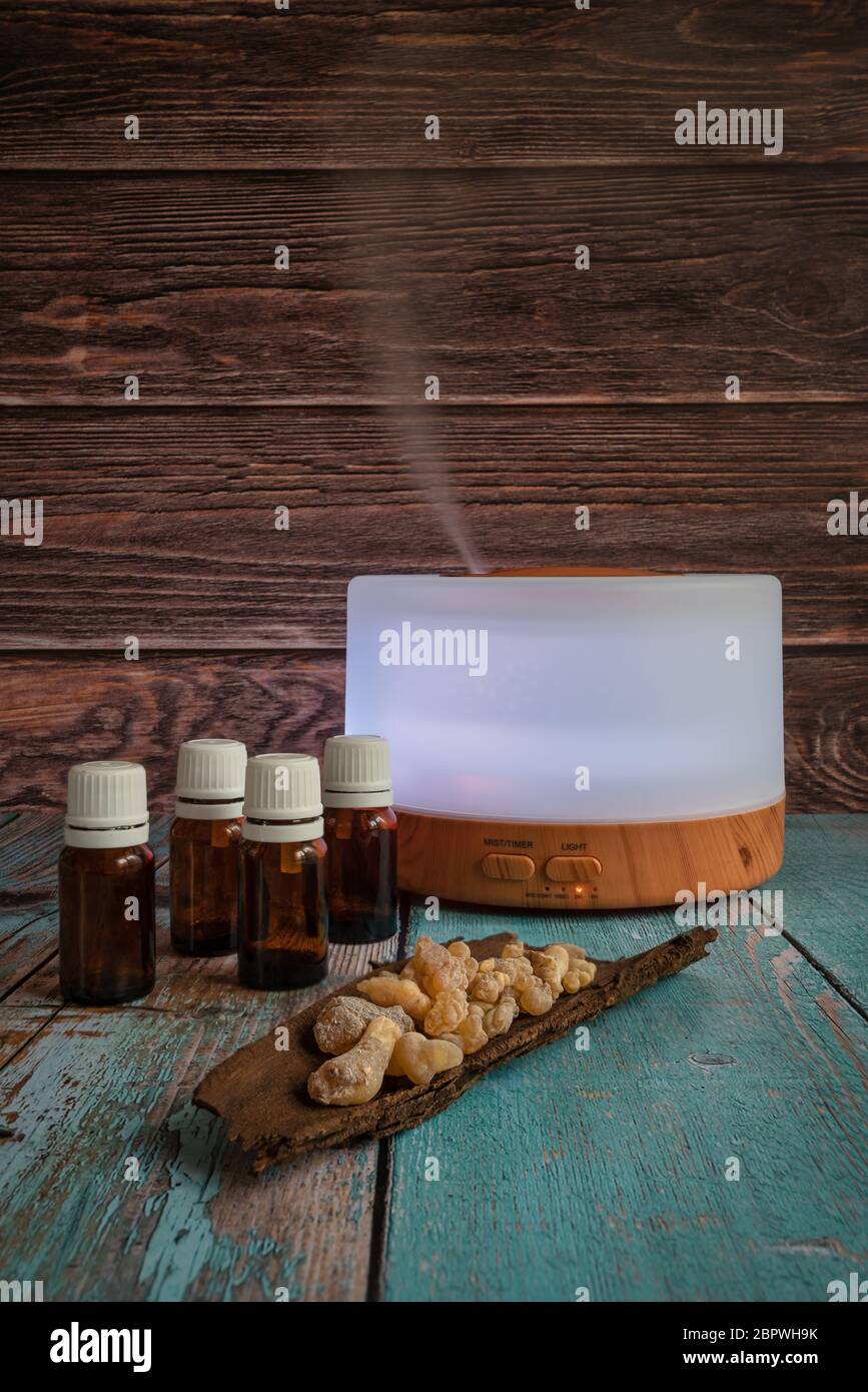Electric oil diffuser with bottles and frankincense, vertical format ...