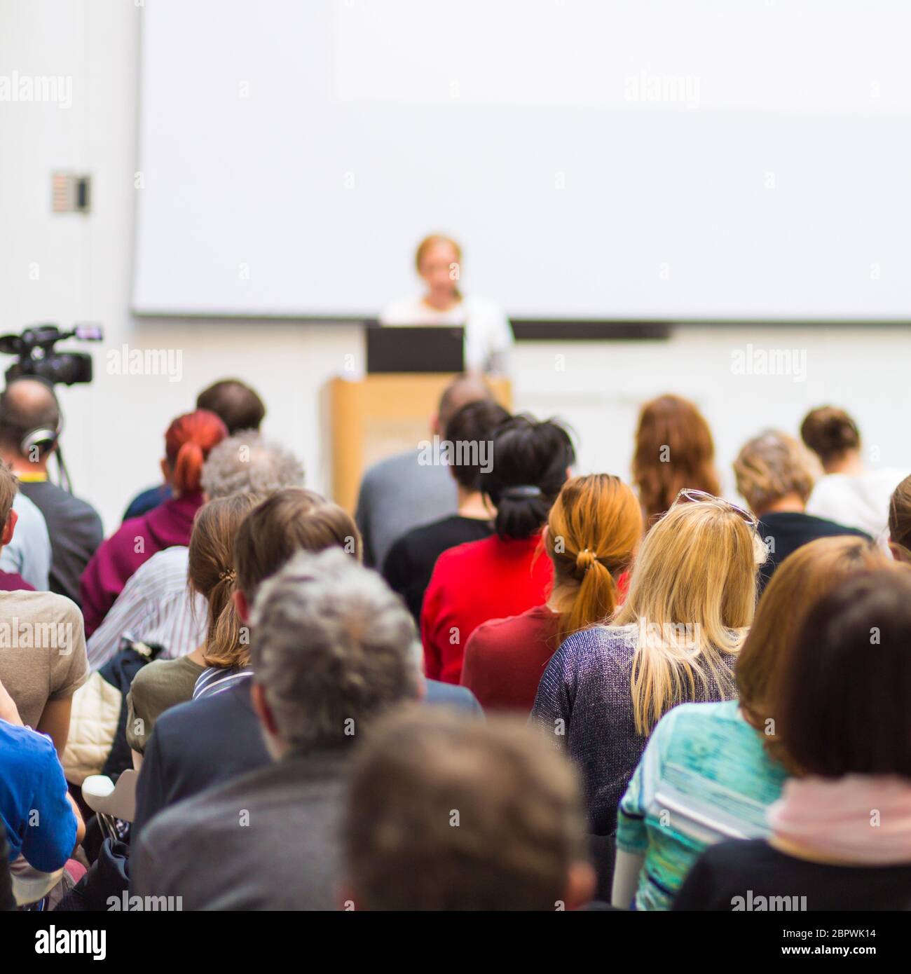 Woman giving presentation on business conference Stock Photo - Alamy