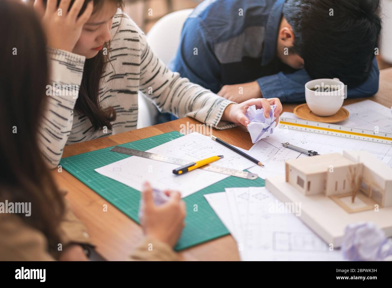 Group of an architect feel stressed after working on architecture model ...