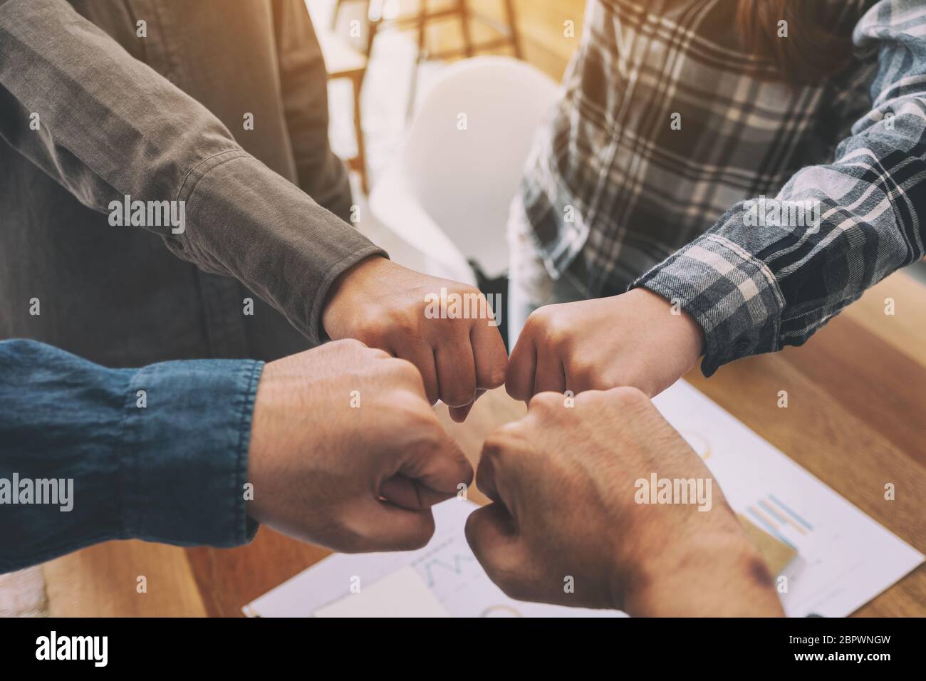 Group of business teamwork join their hands together with power and ...