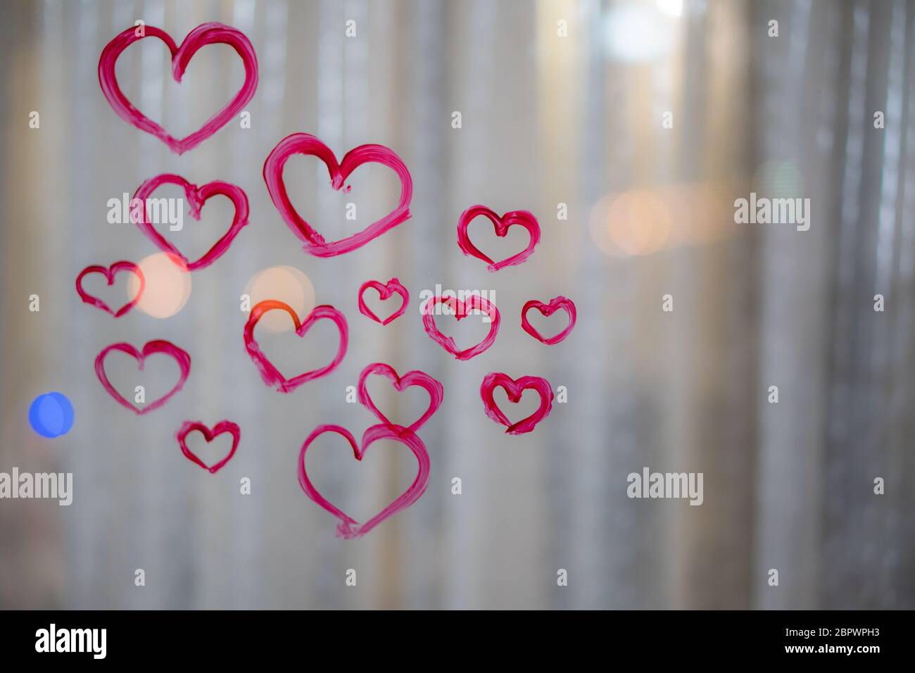 Woman drawing a heart on window hi-res stock photography and images - Alamy