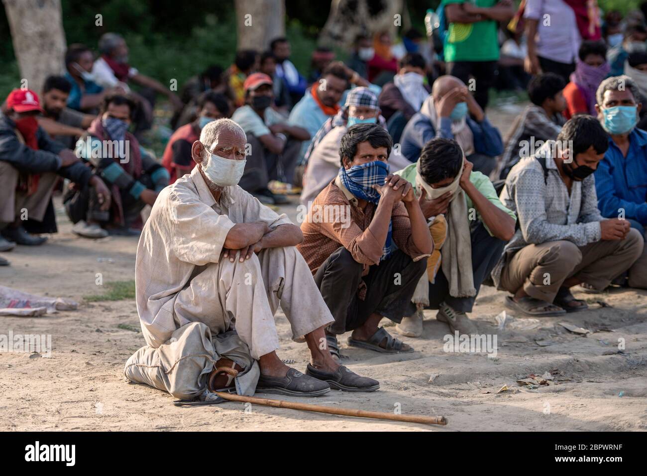 Indian migrant laborers and homeless people wait as they are evicted ...