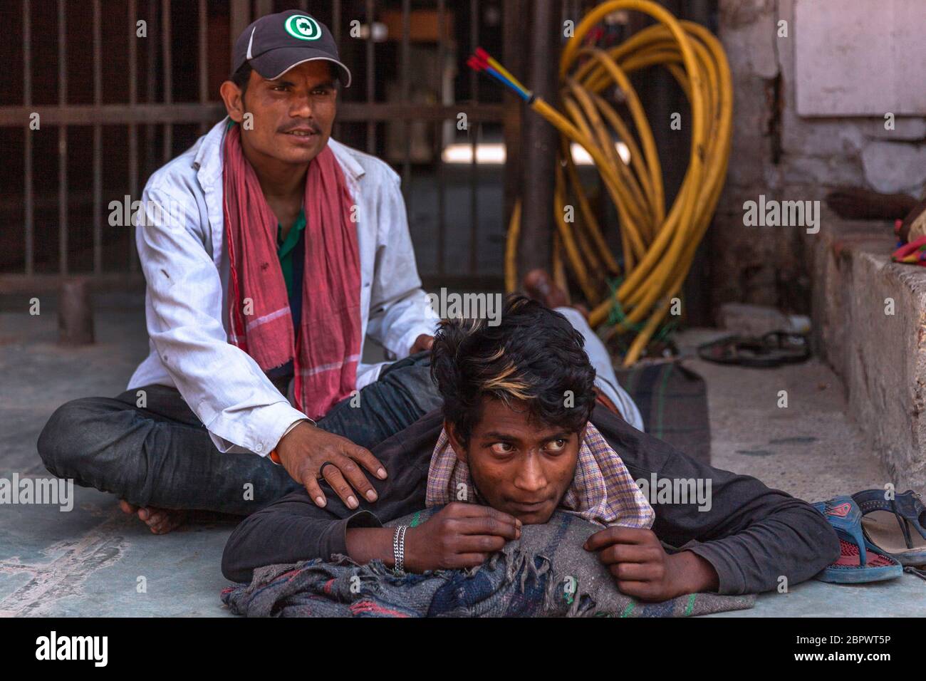 Indian homeless people living on a deserted footpath, as India remains ...