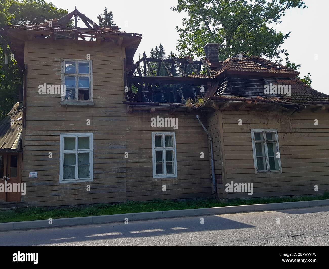 horizontal close up image of a roof of a house that has burned and ...