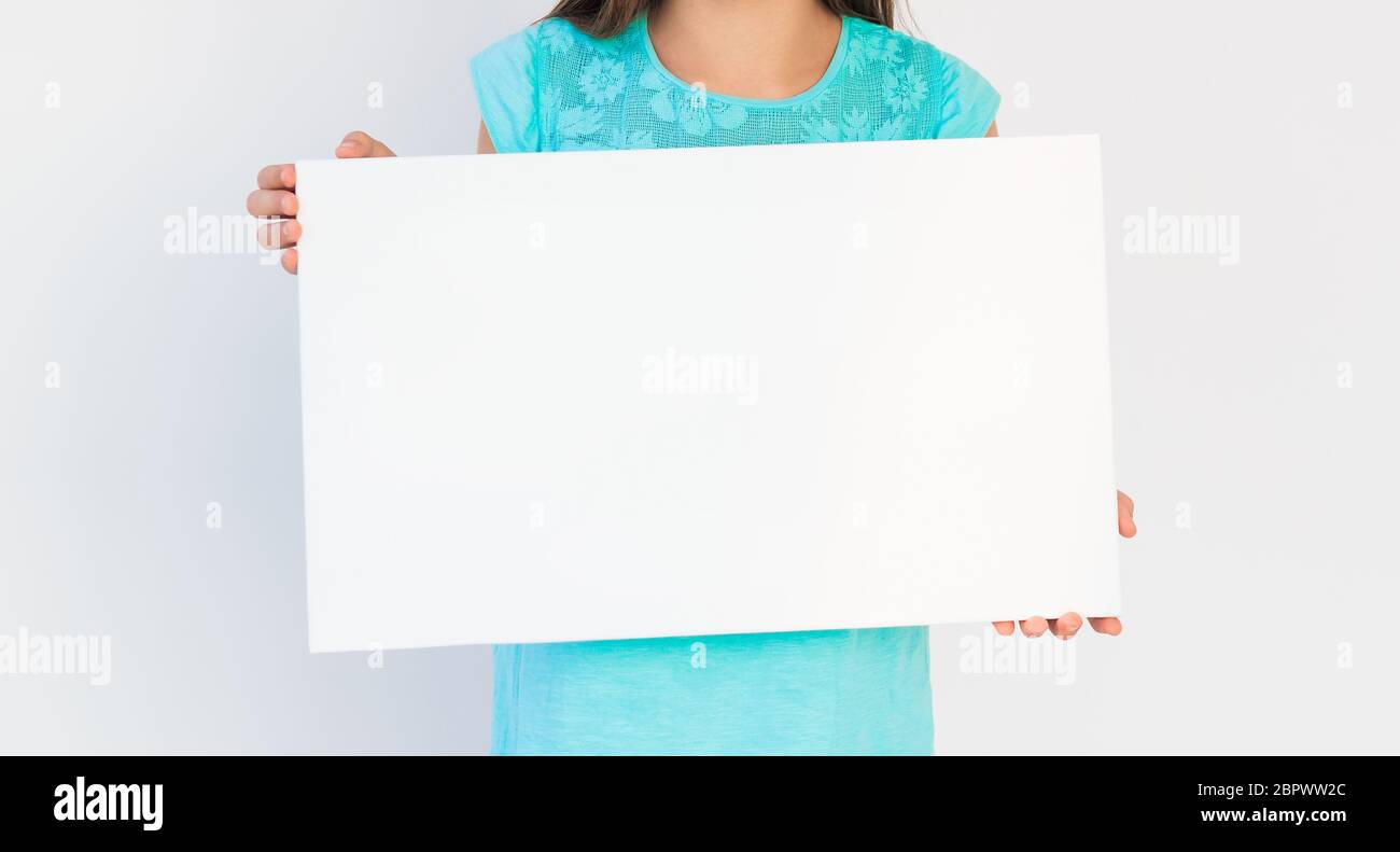 Teen girl holding sheet of paper Stock Photo - Alamy