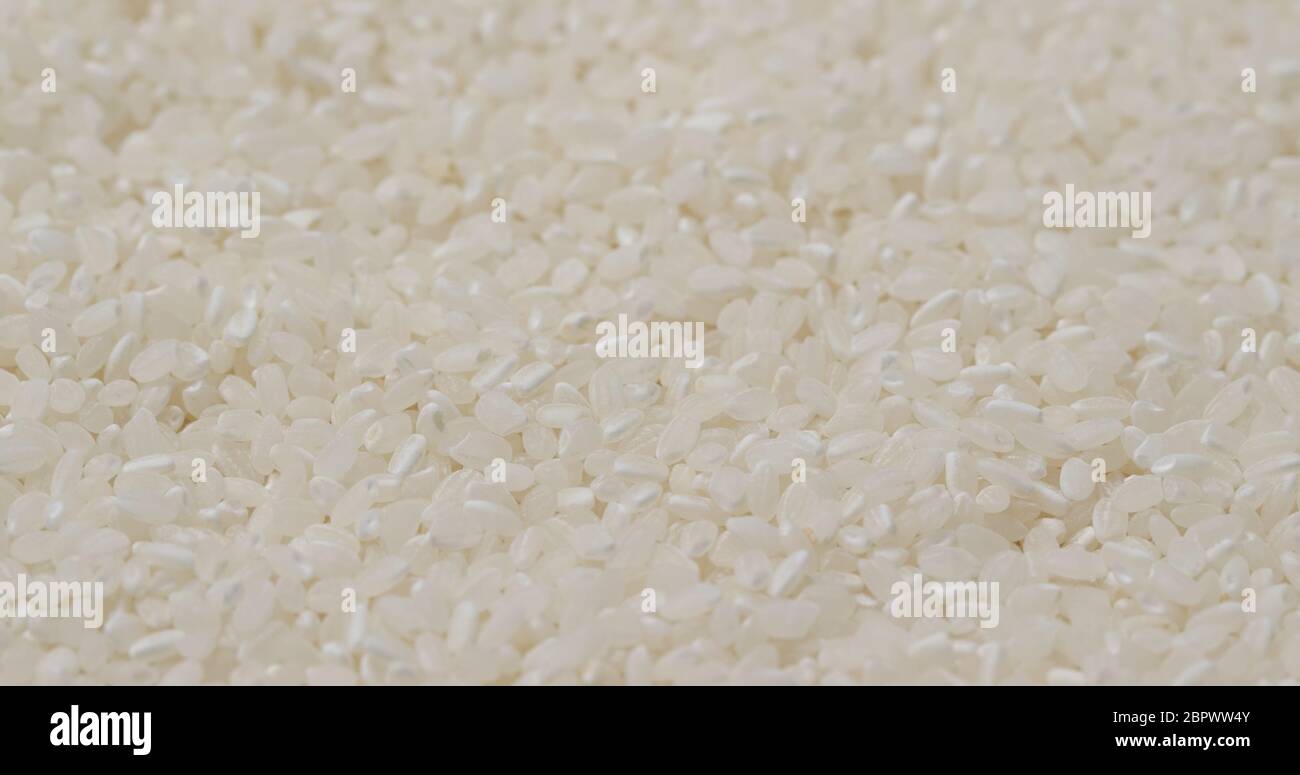 White uncooked rice Stock Photo - Alamy