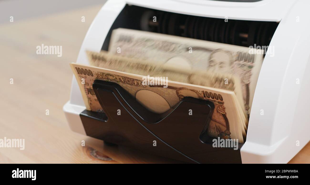 Japanese banknote on Money counting machine Stock Photo - Alamy