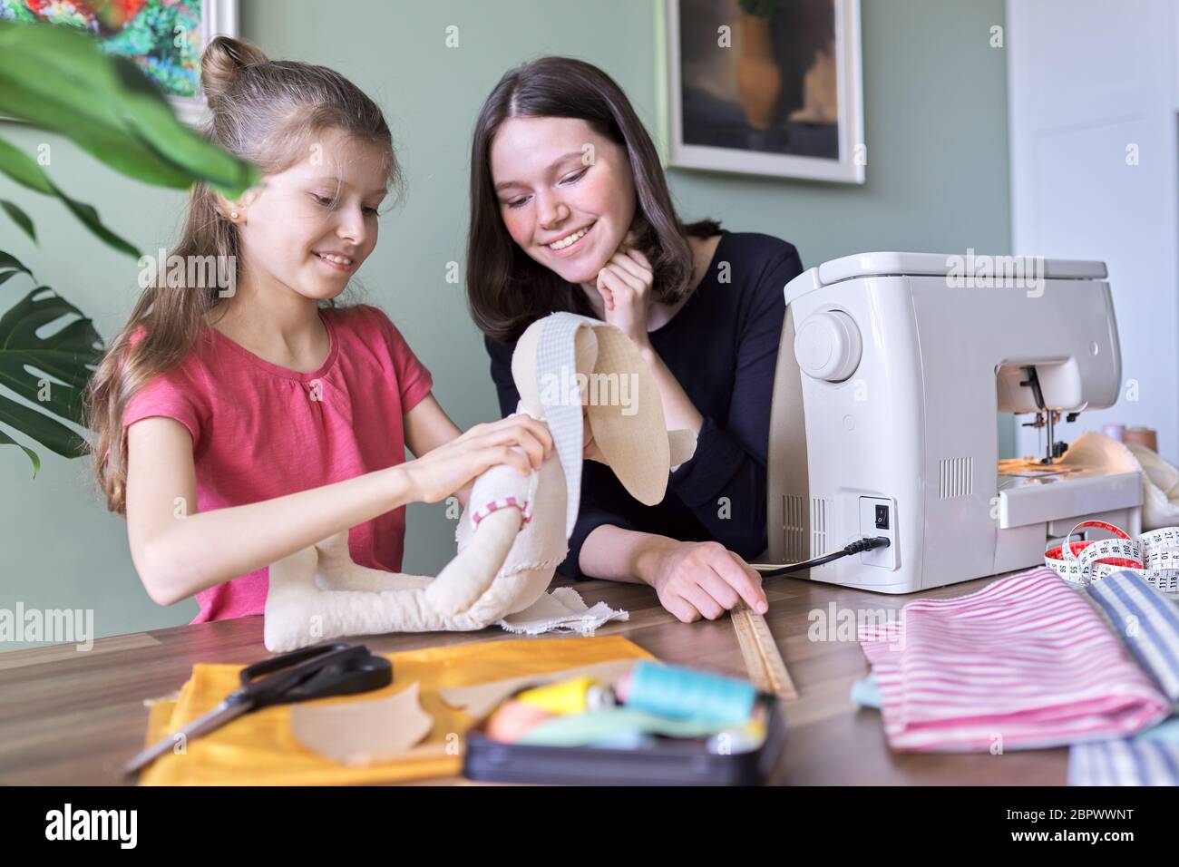 Girls together sewing hi-res stock photography and images - Alamy
