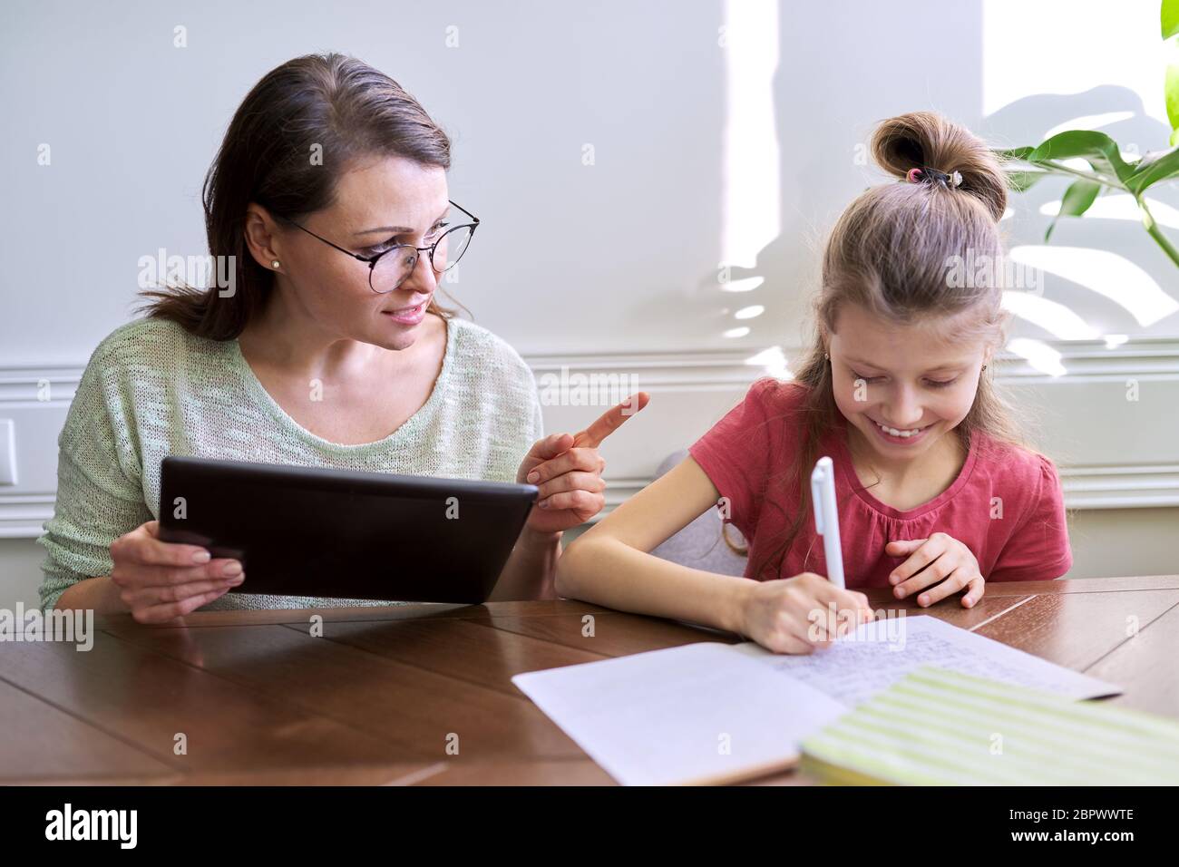 Mother and daughter child study together at home Stock Photo - Alamy