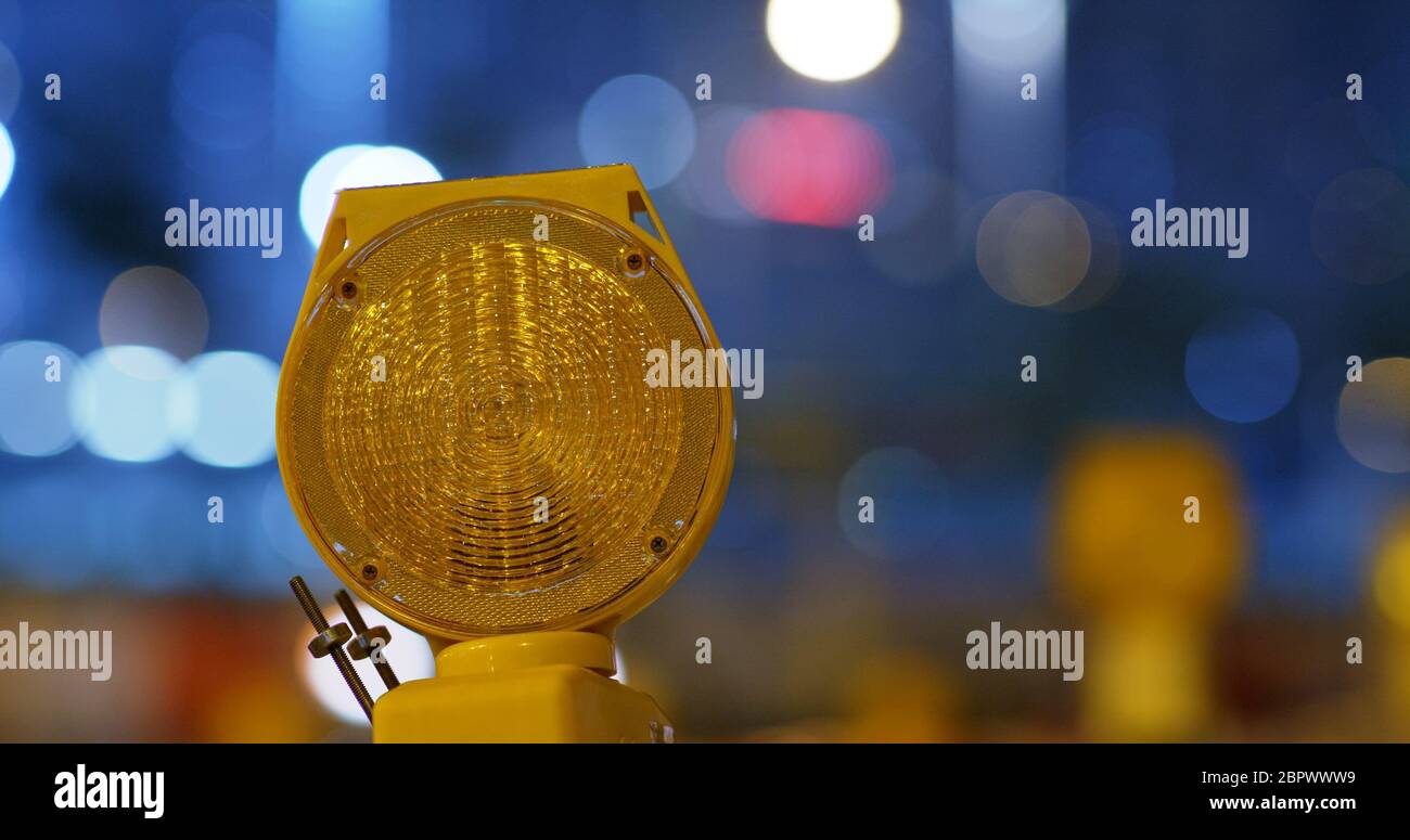 Yellow caution light in the street at night Stock Photo - Alamy