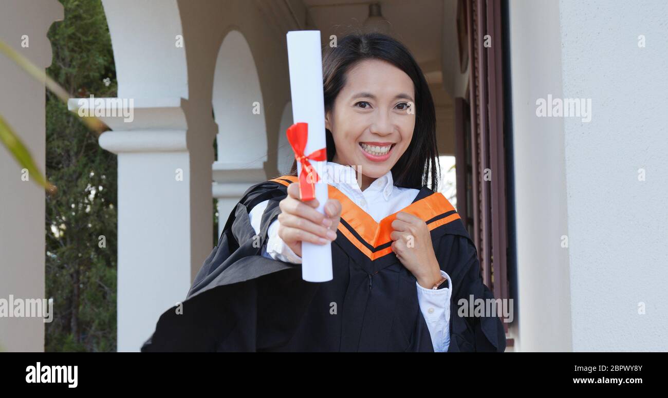Woman get graduation and holding paper certificate Stock Photo - Alamy
