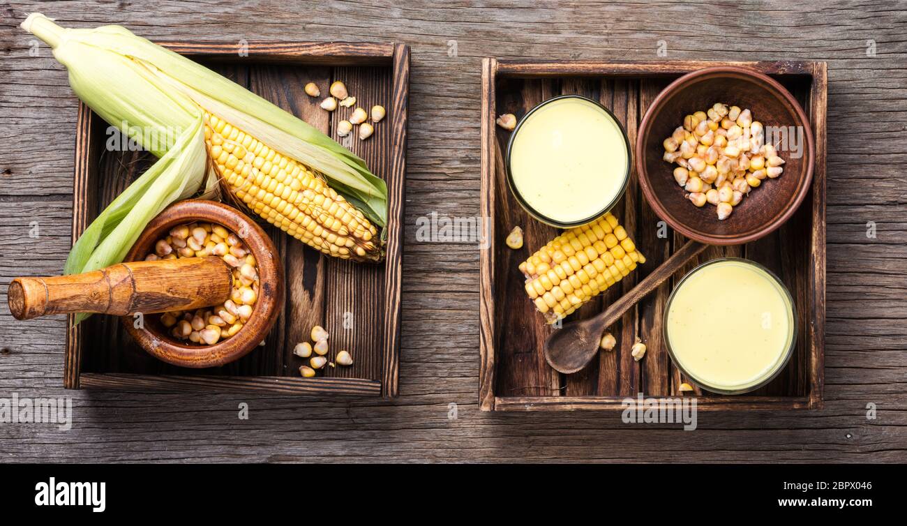 Fresh sweet corn juice.Healthy drink.Corn milk in glass on wooden table ...