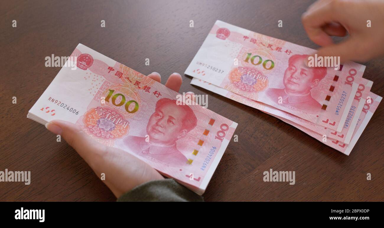 Woman counting yuan banknotes hi-res stock photography and images - Alamy