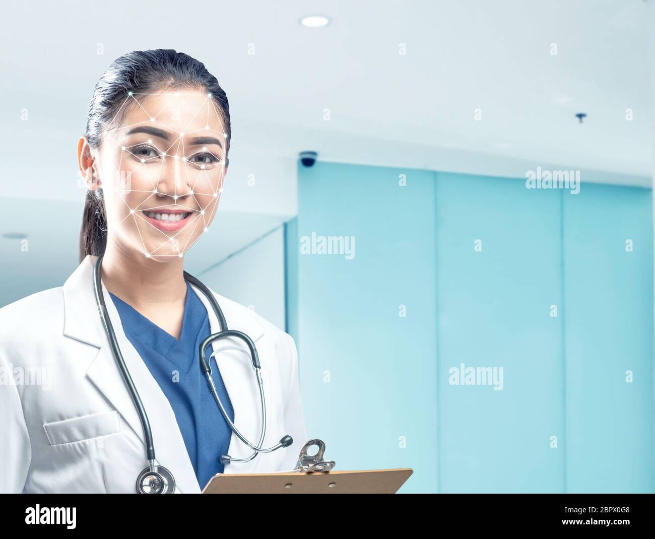 Pretty asian female doctor in white coat and stethoscope holding ...