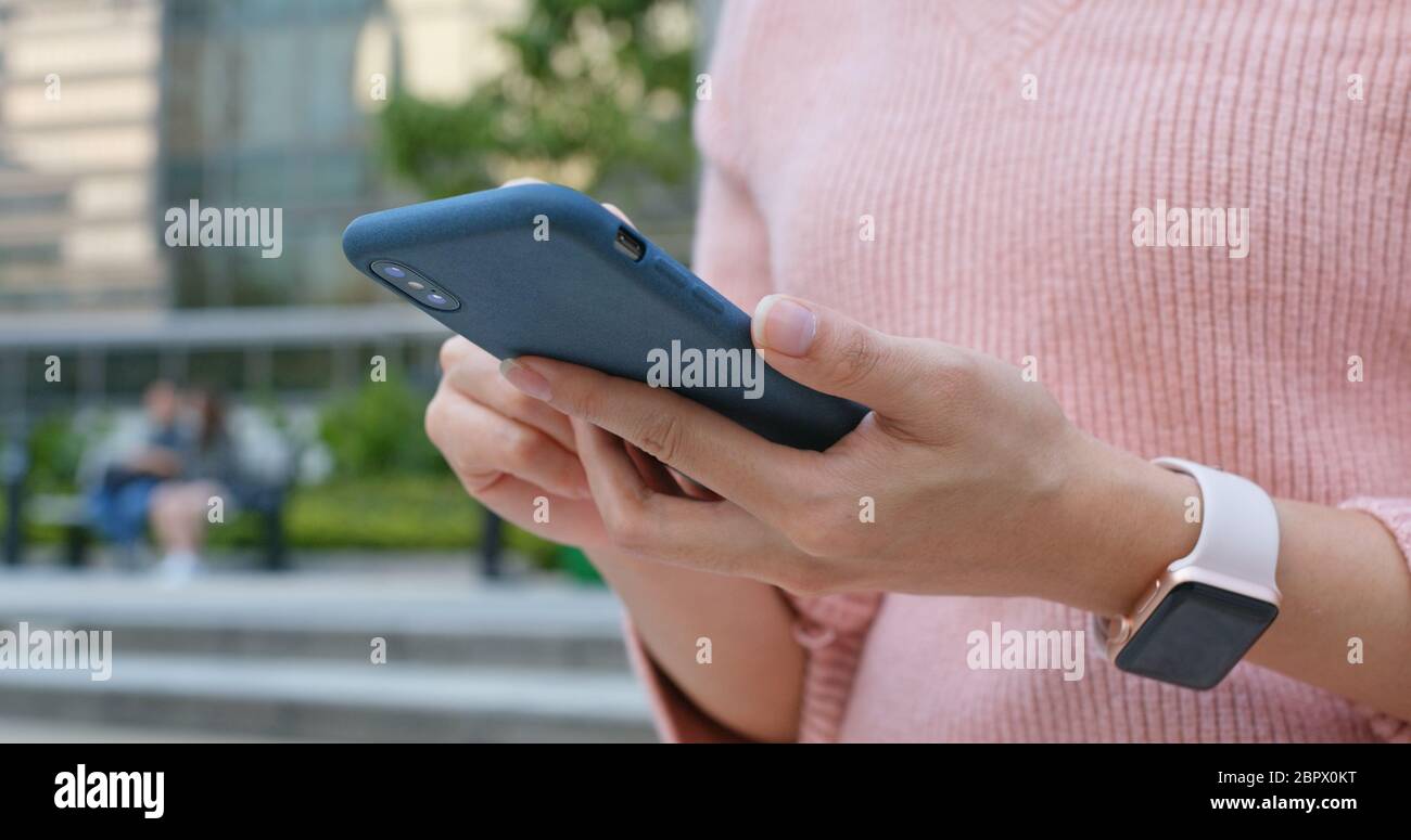 Woman use of mobile phone in the street Stock Photo - Alamy