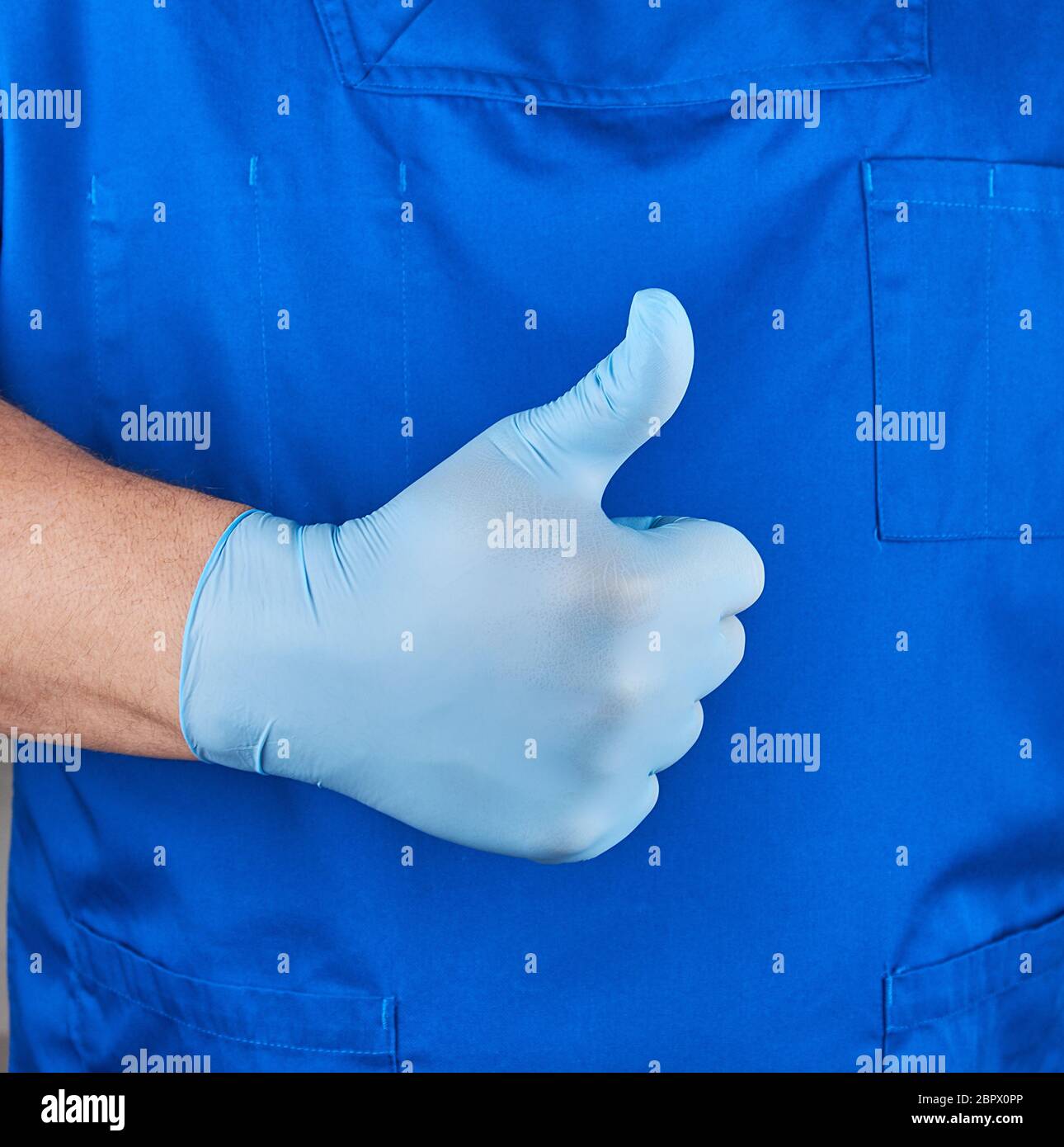 doctor in blue uniform shows a gesture of approval, like, close up ...