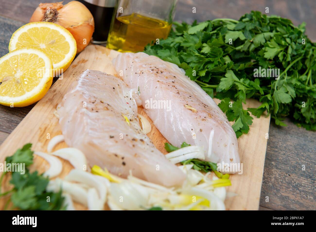 Fresh fish, a raw cod fillets with addition of herbs and lemon Stock ...