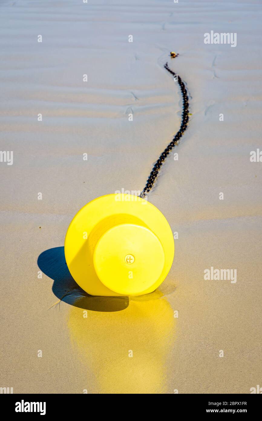 A large yellow buoy and its anchorage chain, used as a launching ...