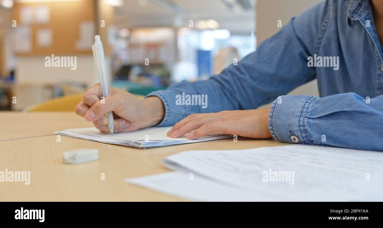 Woman write on the paper with cellphone at home Stock Photo - Alamy