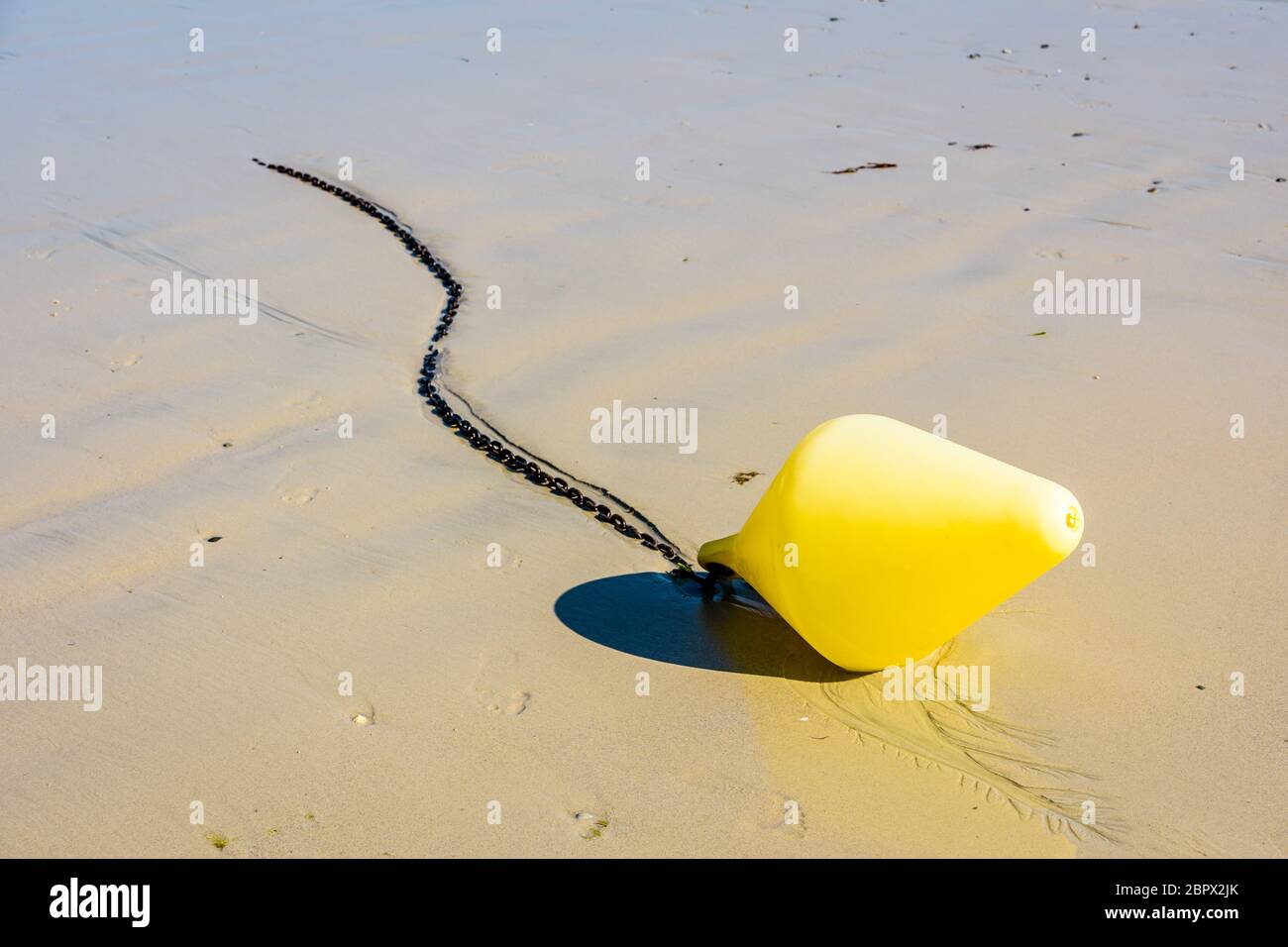 A large yellow buoy and its anchorage chain, used as a launching ...