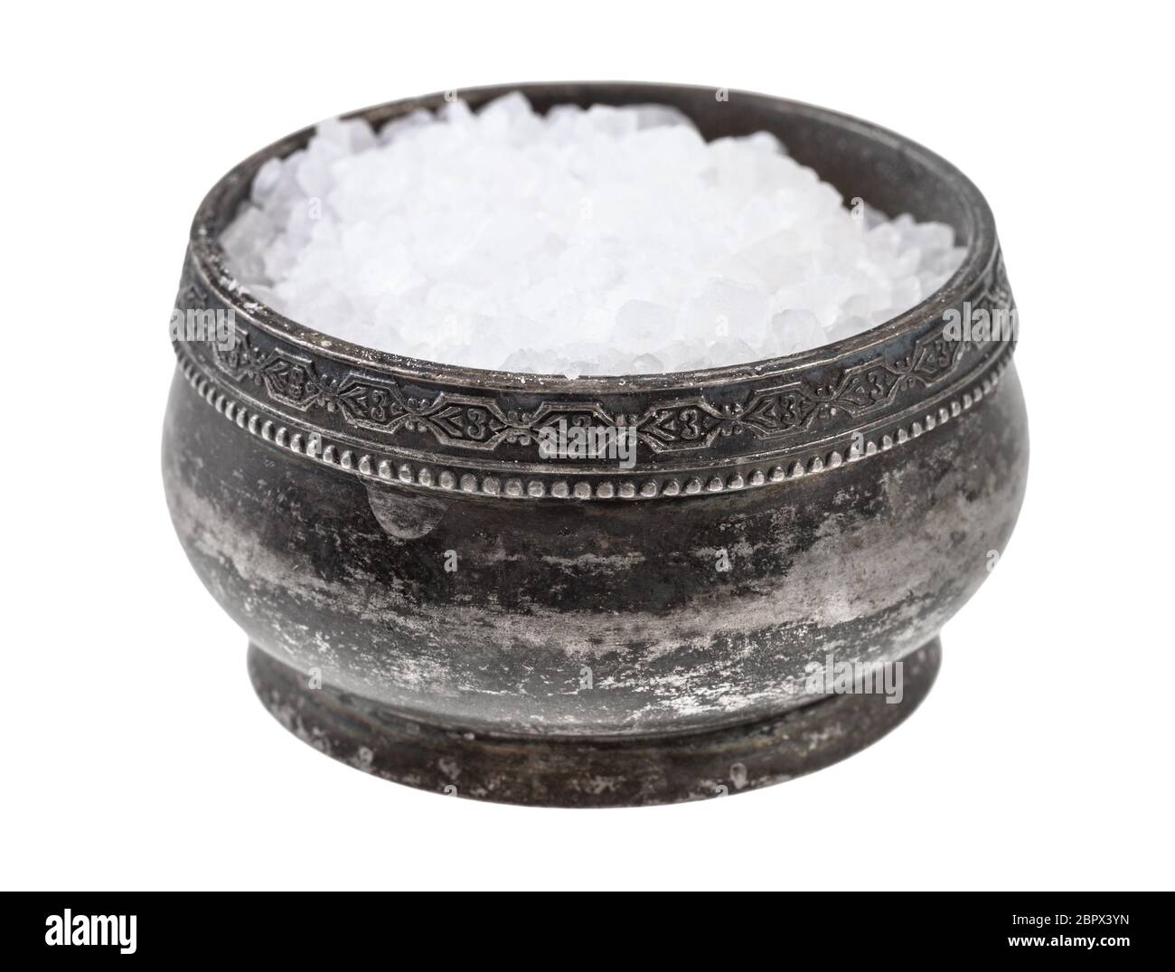 side view of old silver salt cellar with coarse grained Sea Salt ...