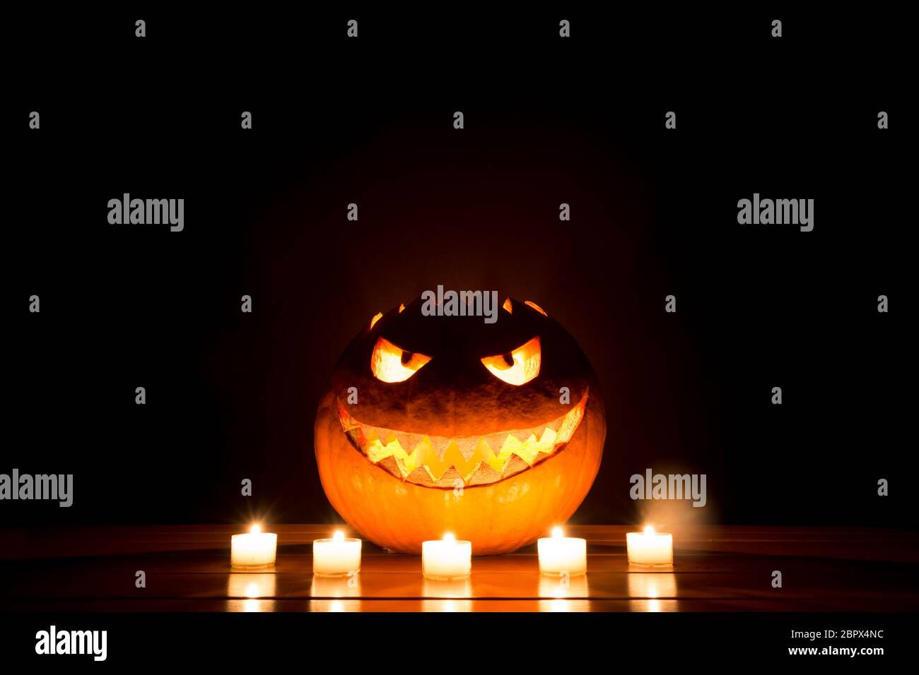 Big spooky helloween symbol has a glowing mad face and smiling with ...