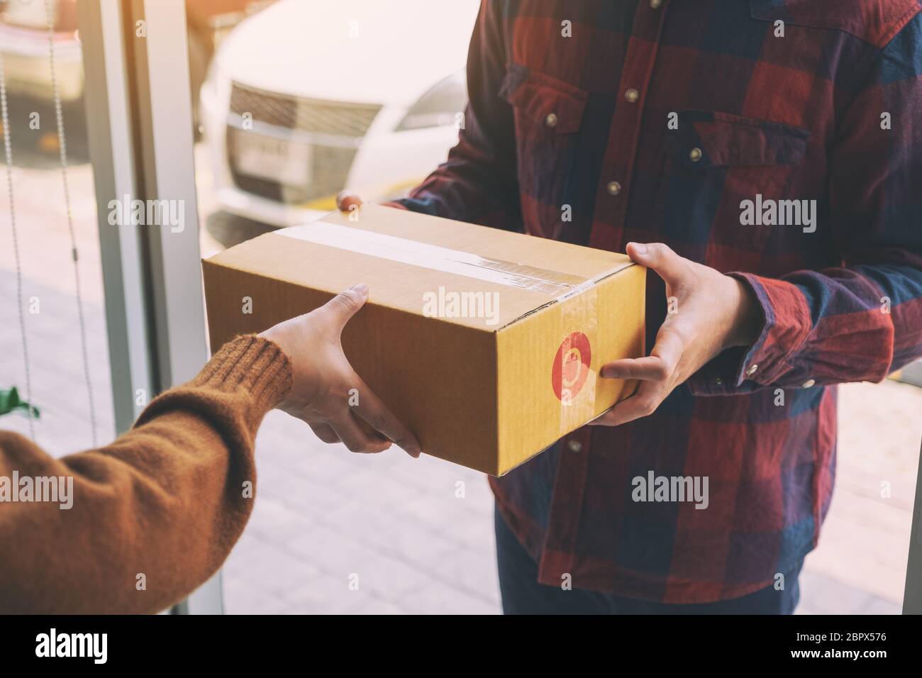 woman receiving parcel box from delivery man at the house's door Stock ...