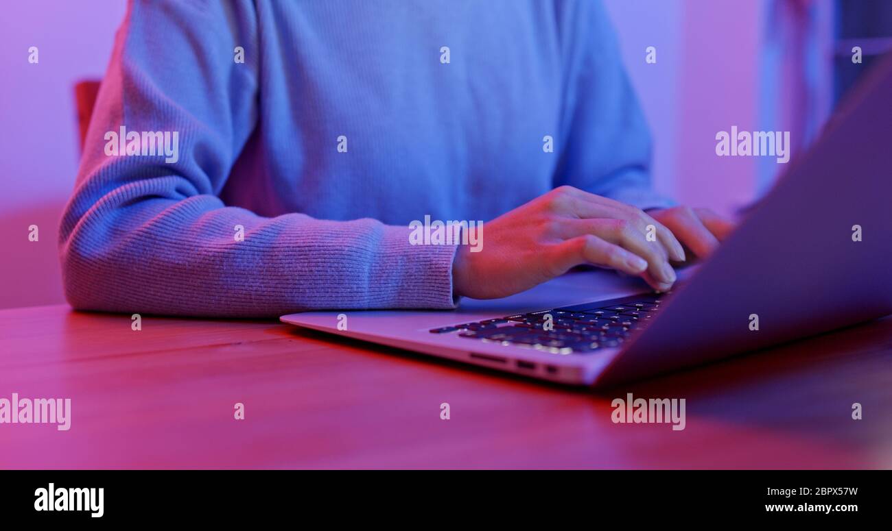 Work on laptop computer with purple light Stock Photo - Alamy
