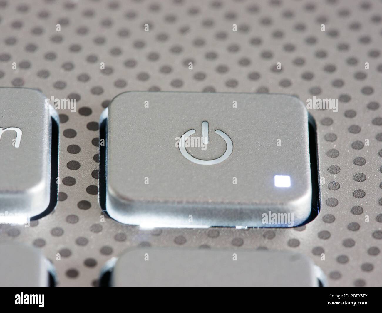 Silver laptop power button close up. Shallow DOF Stock Photo - Alamy